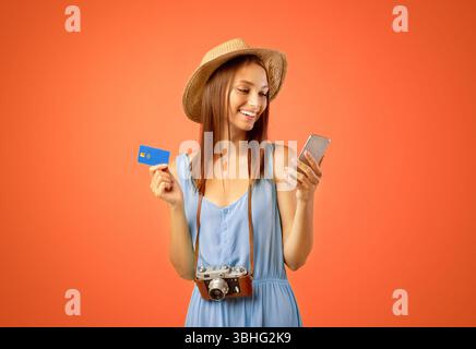 Happy female tourist in a yellow down jacket with a backpack admires ...