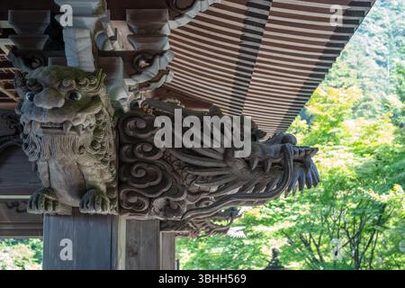 Intricate wooden dragon carving adorns Daisho-in Temple, blending ...