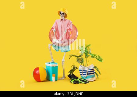 Human skeleton and beach accessories on yellow background with space ...