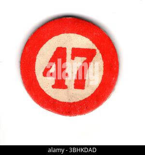 A vintage numbered lotto or bingo counter isolated on a white ...