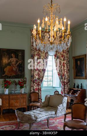 Elegant castle salon with crystal chandelier and period furniture ...