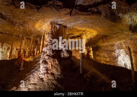 Impressive limestone formations and flowstone cascades with golden ...
