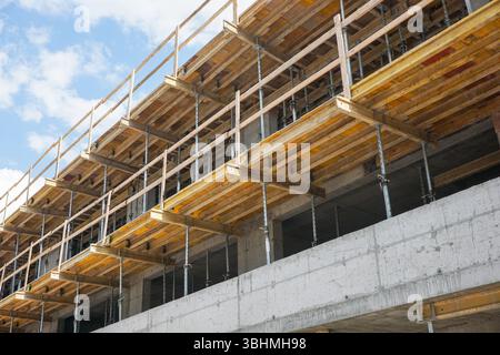 Workers build structure with wooden frames beams bracing in ...