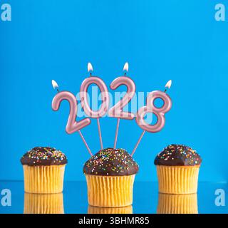 Christmas sweet cupcakes and candles in form of numbers 2023. White ...