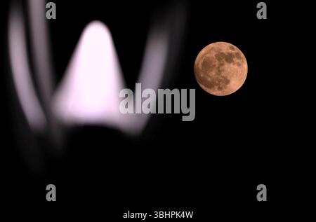 Baghdad, Iraq. 10th June, 2025. A full moon is seen in the sky of ...