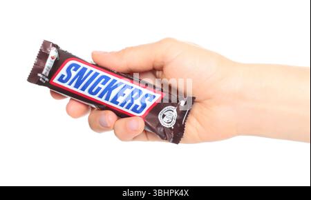 Hand holding Package of the Snickers - Chocolate Bar of Mars ...