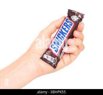 Hand holding Package of the Snickers - Chocolate Bar of Mars ...