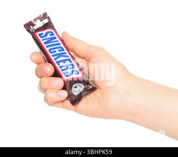 Hand holding Package of the Snickers - Chocolate Bar of Mars ...