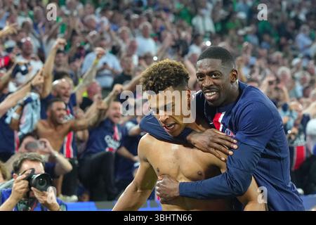PSG's Ousmane Dembele and PSG's Desire Doue pose with the trophy after ...