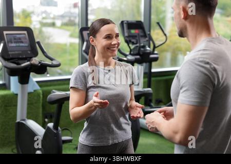 Professional personal trainers talking in sport center Stock Photo - Alamy