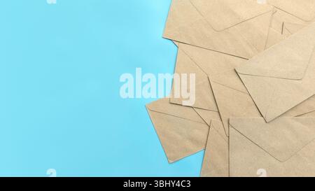 A stack of brown envelopes on blue background with copy space Stock ...