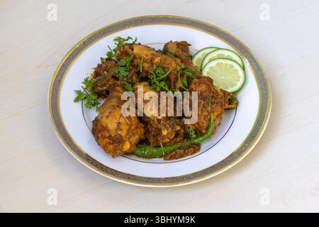 Delicious Irani Chicken Karahi Bhuna Curry on white plate with wooden ...