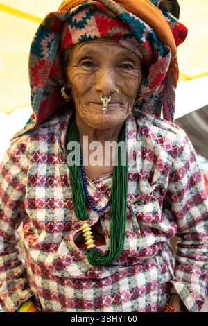 An elderly woman from Eastern Nepal wears a Bulaki which is a ...