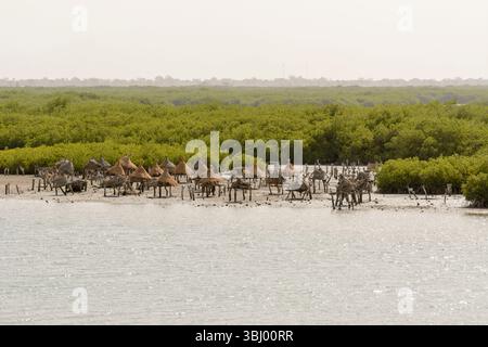 Grain is stored in granaries on stilts at Joal-Fadioth (Joal-Fadiot ...