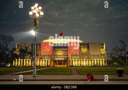 A Vietnam flag and hammer and sickle illuminated on the front of the ...