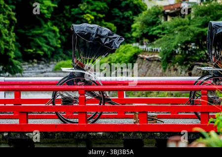 Jinrikisha, or rickshaws, parked in a popular tourist location during ...
