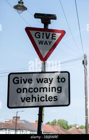 UK road sign with a triangular "Give Way" warning above a "Give way to ...