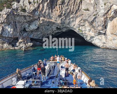 A tourist cruise boat enters the Papanikolis Cave on the south west ...