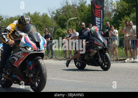 A yellow motorcycle from behind in front of a building in Istria ...