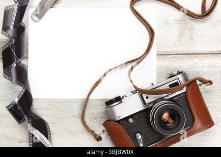 Retro camera with empty paper and negative film on wooden table from ...