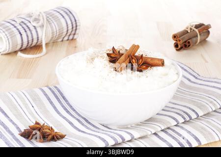 rice pudding with cinnamon and anise star in white bowls with ...