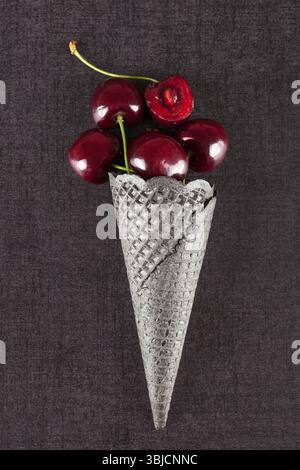 Cone ice cream with black cherry flavor Stock Photo - Alamy