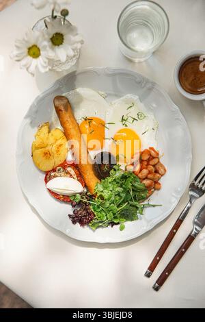Top view of fried eggs with sausage, bread and vegetable Stock Photo ...