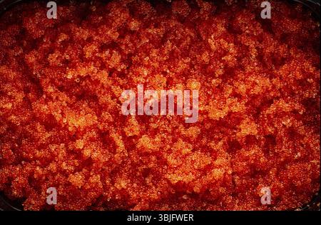 Container with orange caviar, flying fish, Tobiko, on the table, caviar ...