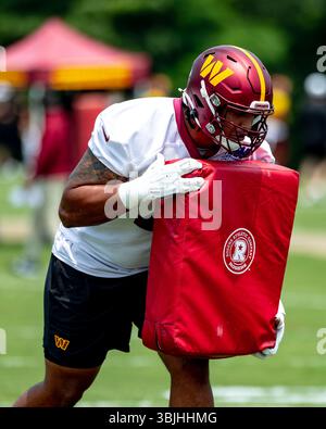 Washington Commanders offensive tackle Brandon Coleman (74) works out ...