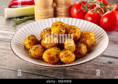 Baked small baby potato with herbs and spices Stock Photo - Alamy