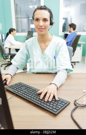 medical secretary typing report on deskop computer Stock Photo - Alamy