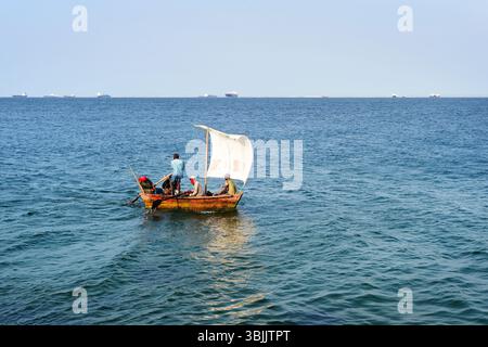 LUANDA, ANGOLA - FEB 03, 2025: People at a fishing boat on the beach of ...