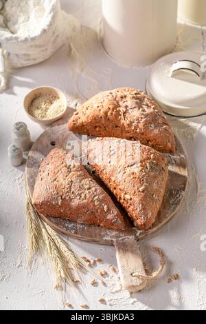 Brown and tasty triangular buns freshly baked in home bakery ...