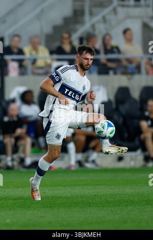 Vancouver Whitecaps defender Tristan Blackmon, left, heads the ball ...