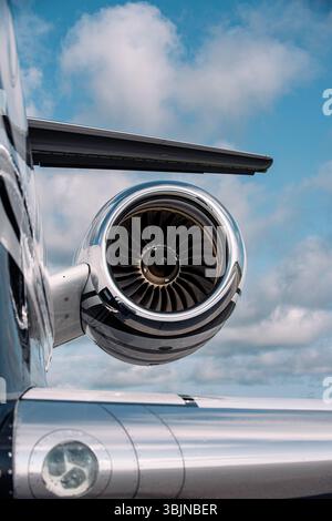 Jet engine and T-tail of a luxury Gulfstream business jet under partly ...