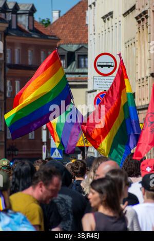 Participants march with a banner during the parade. Hundreds of ...