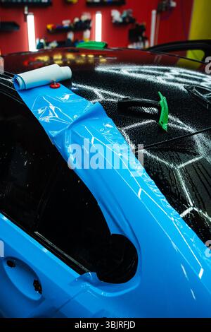 PPF Paint Protection Film Tools on Car Hood. Car wrap tools, including ...