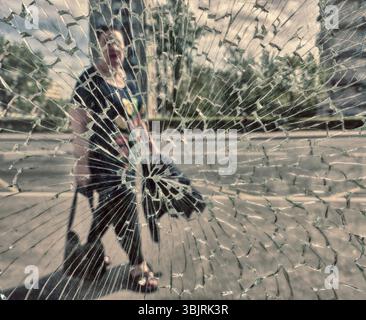 View of city and people through cracked glass. City as habitat with ...
