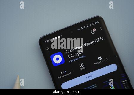 Dhaka, Bangladesh- 29 May 2025: On a blue surface, a smartphone displays the Uniswap app within ...