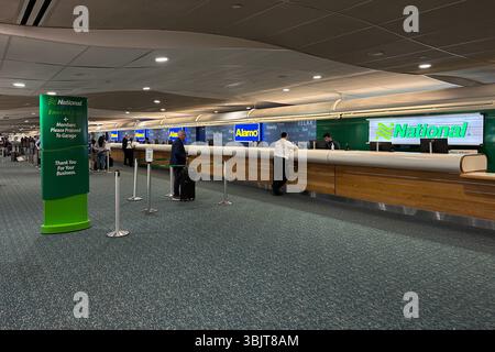Travelers wait in line at the rental car center at George Bush ...
