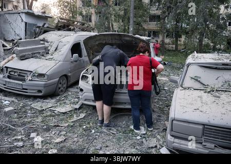 Cars damaged during a Russian strike sit parked amid debris in Kryvyi ...