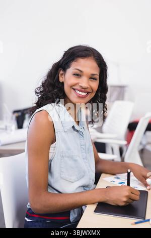 Young hispanic woman artist drawing on touchpad at art studio Stock ...