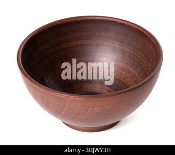 empty rustic terracotta kitchen bowl and spoon on a wooden tabletop ...