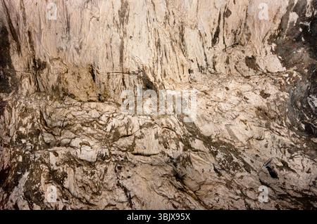 Inside a cave with calcium carbonate rock formation with stalactites ...