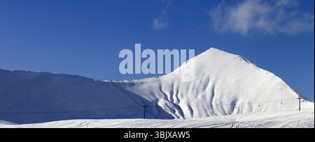 Panoramic view on snowy off-piste slope with skier and snowboarders at ...