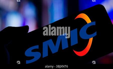 SMIC logo is displayed on smartphone. Semiconductor Manufacturing ...