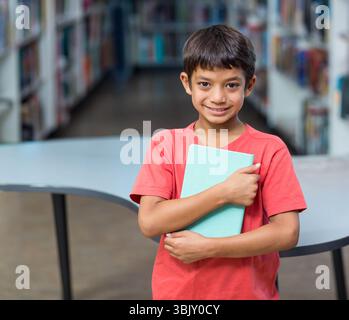 Teenager hispanic boy wearing school bag and holding books smiling ...