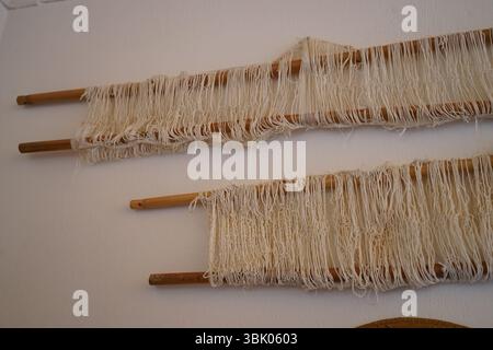Traditional Cretan yarn preparation setup with wooden rods and natural ...