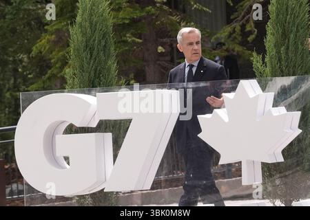 Canada's Prime Minister Mark Carney signs a guest book as he meets with ...