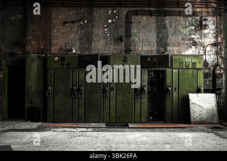 Industrial fuse boxes against damaged wall Stock Photo - Alamy
